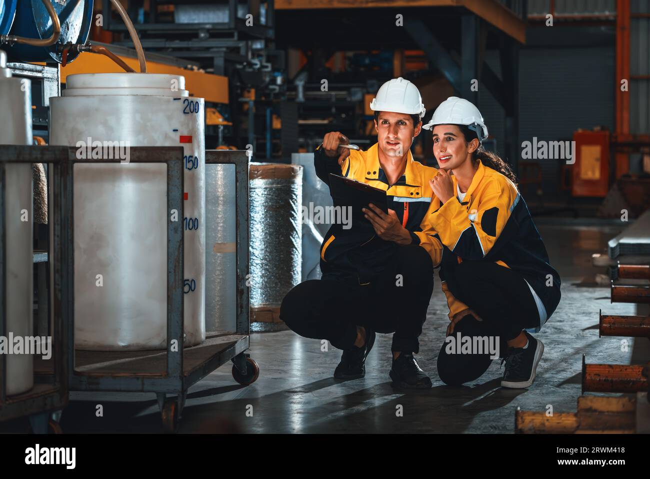 Two factory workers or engineers conduct professional inspection on ...