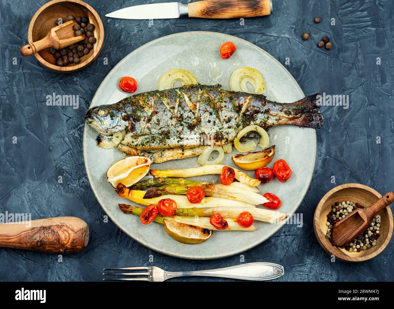Grilled trout prepared with asparagus. Baked salmon fish. Top view ...