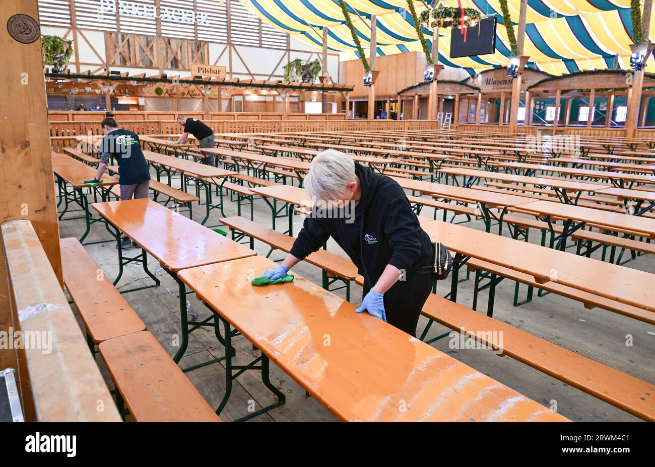 Stuttgart, Germany. 20th Sep, 2023. Employees in a festival tent clean ...
