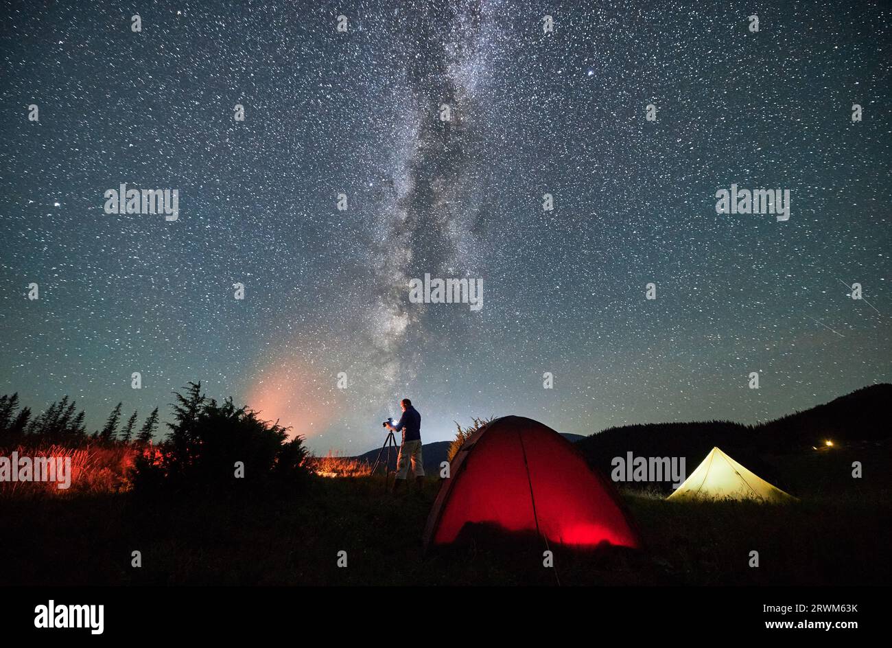 Male photographer taking pictures of Milky way. Man doing photo shoot ...