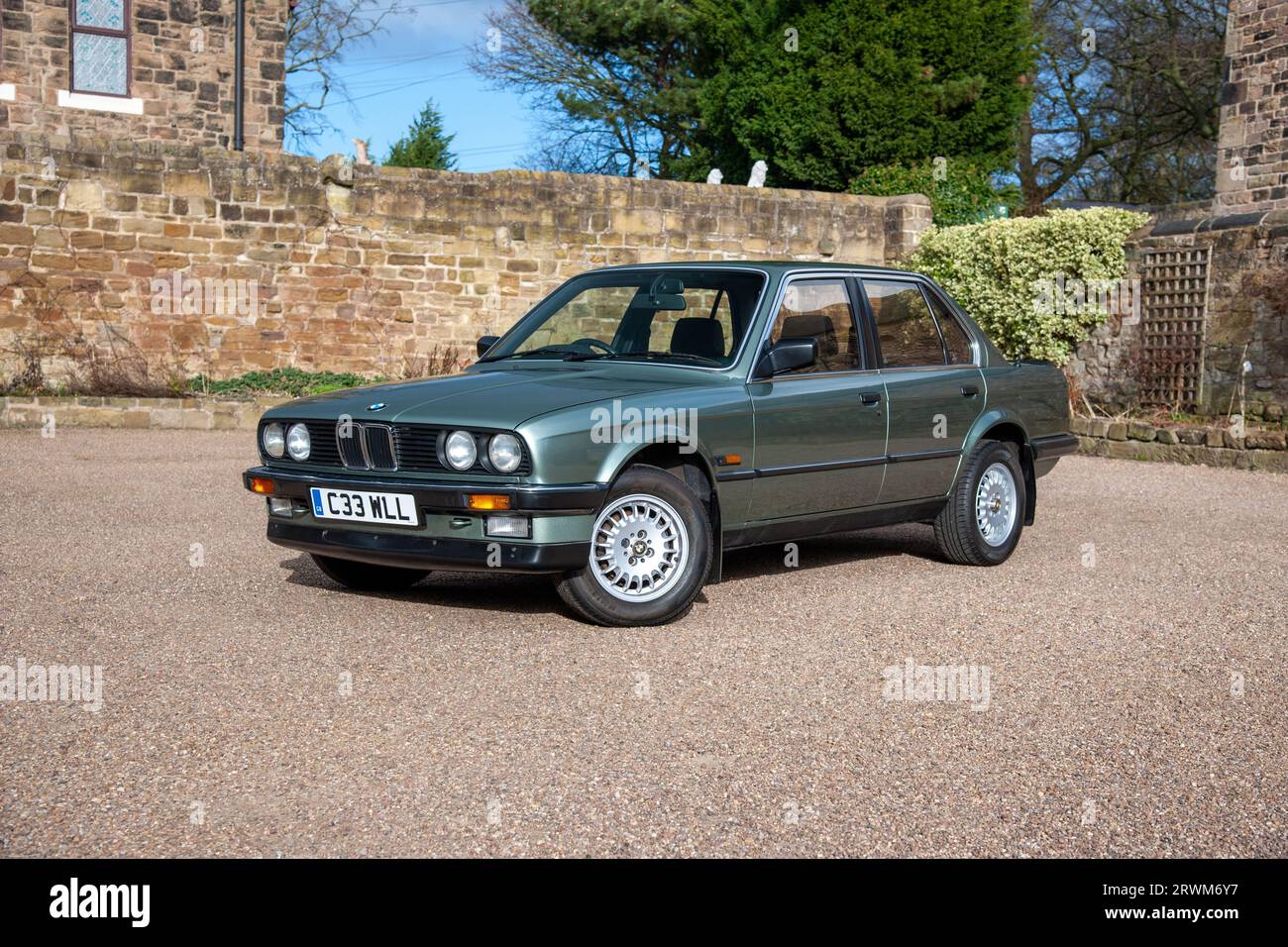 BMW Three Series (E30) four door saloon parked on a gravel courtyard on ...