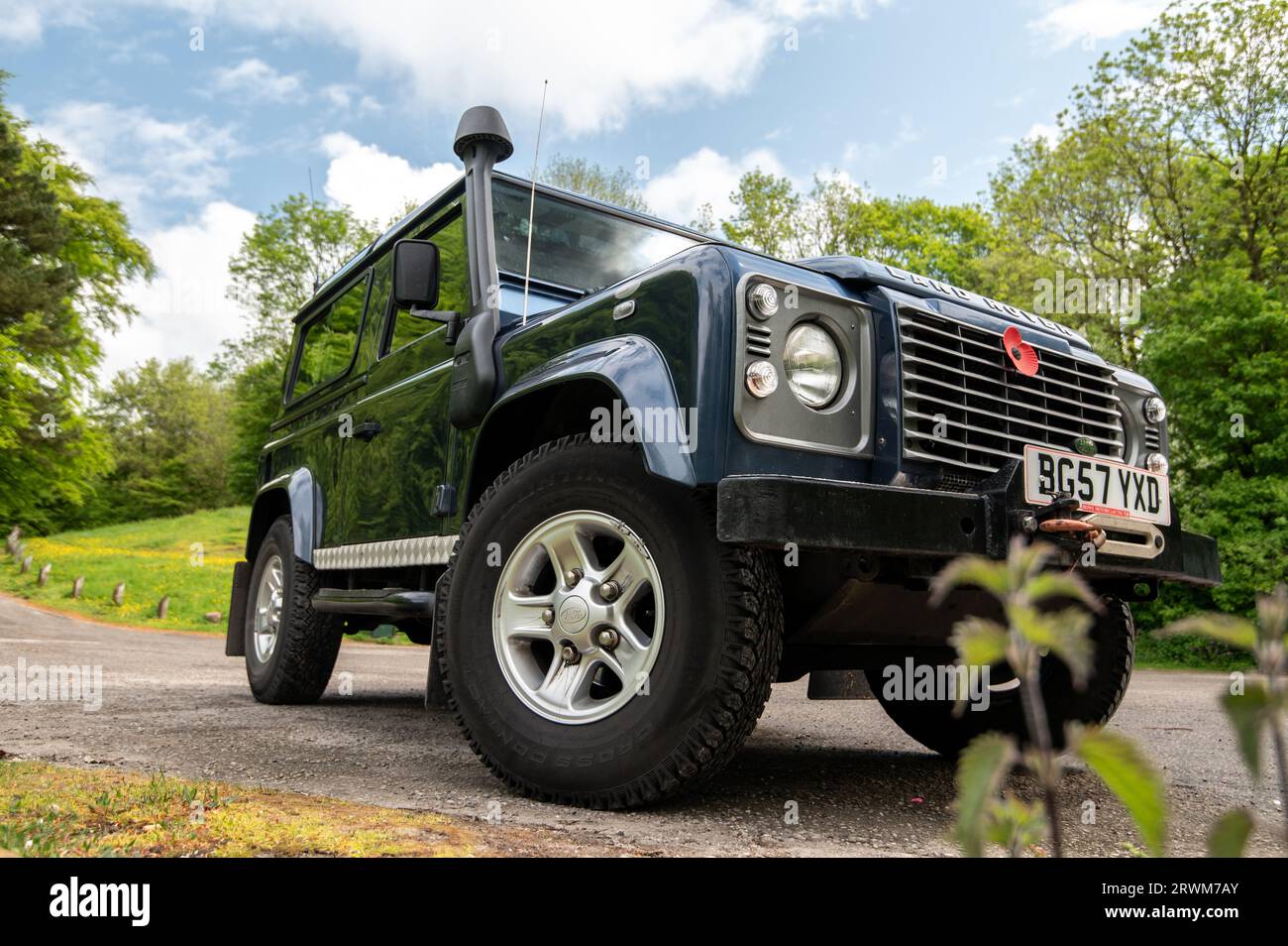 Blue Land Rover Defender equipped with five-spoke alloy wheels and ...