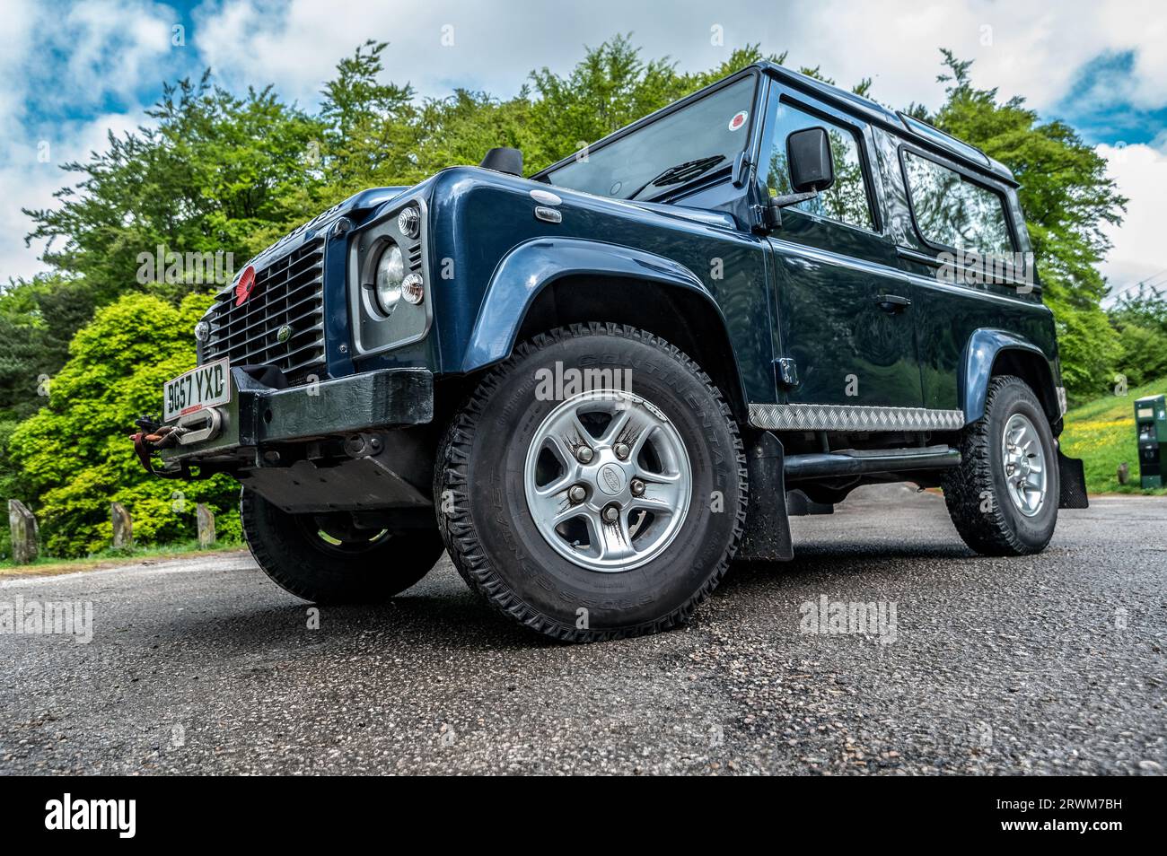 Blue Land Rover Defender equipped with five-spoke alloy wheels and ...