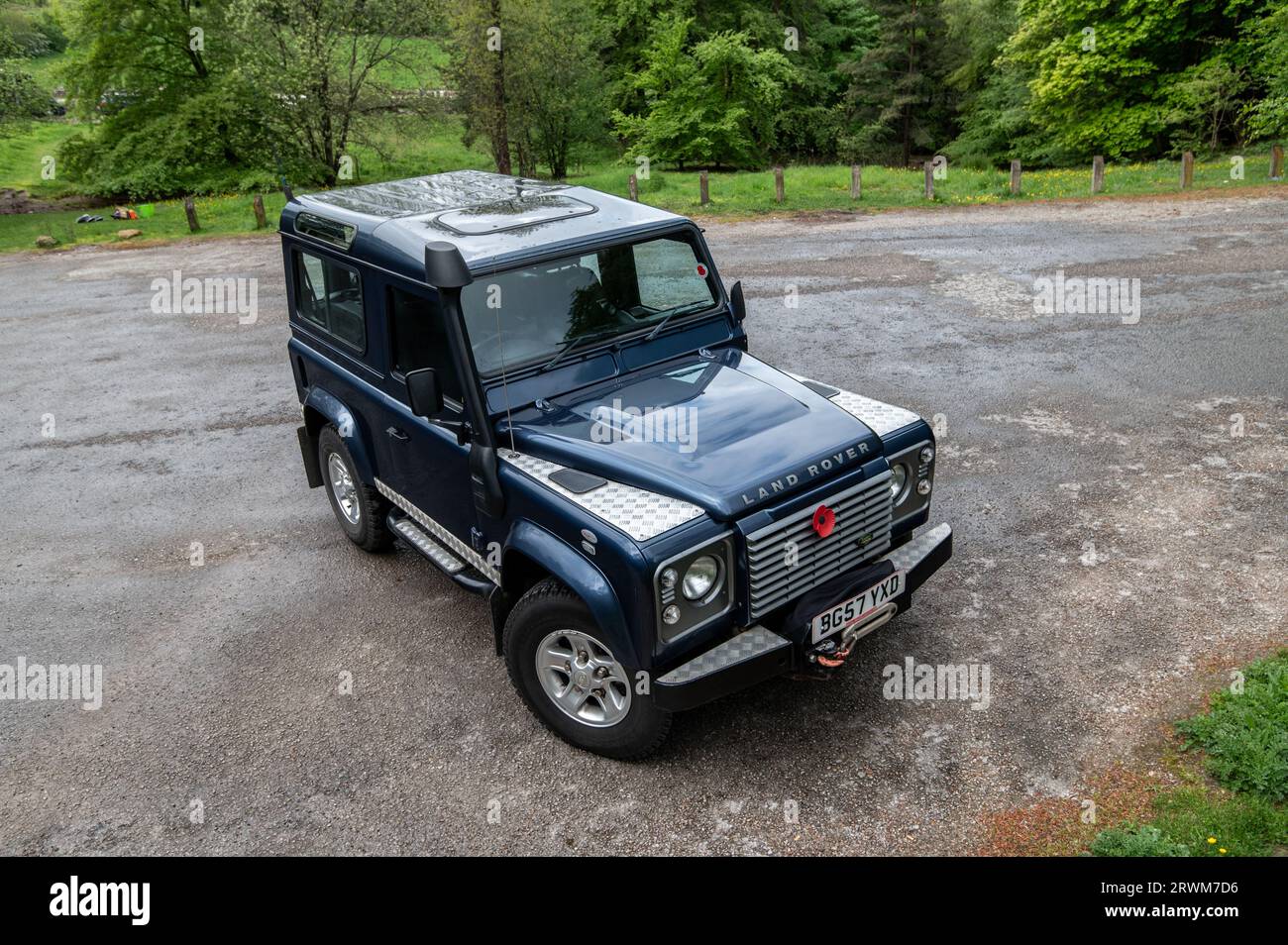 Blue Land Rover Defender equipped with five-spoke alloy wheels and ...