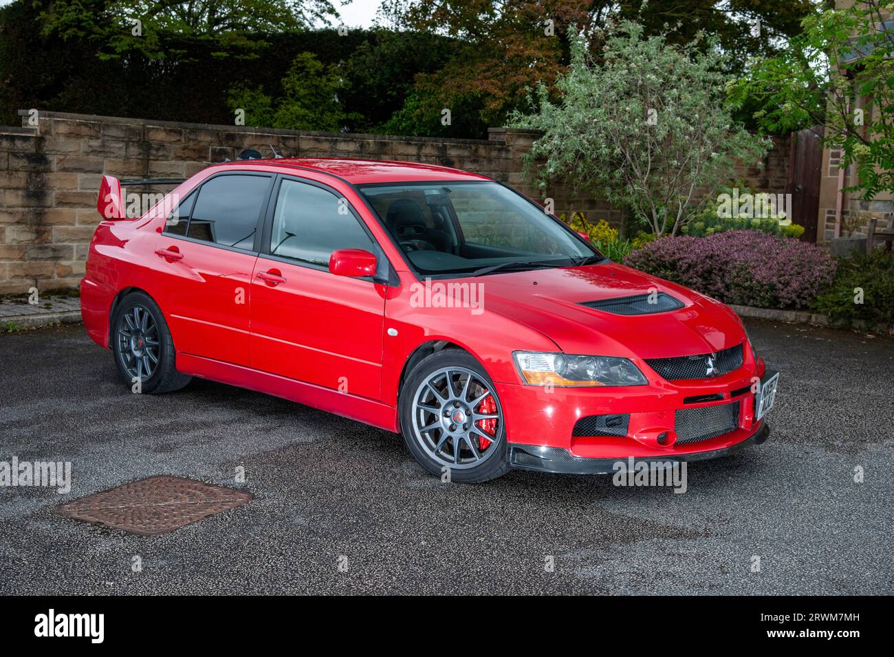 Red Mitsubishi Lancer Evo IX parked in a suburban cul de sac Stock ...