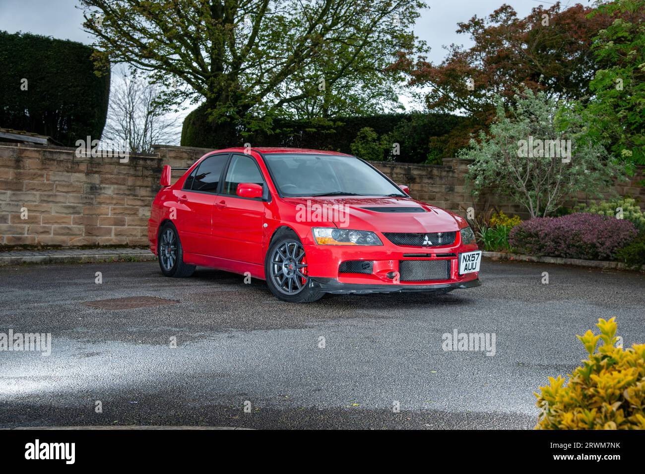 Red Mitsubishi Lancer Evo IX parked in a suburban cul de sac Stock ...