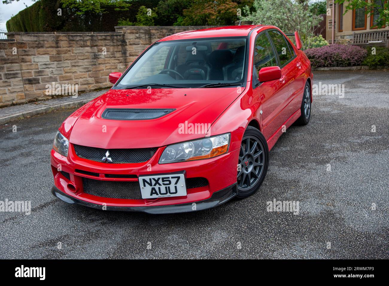 Red Mitsubishi Lancer Evo IX parked in a suburban cul de sac Stock ...
