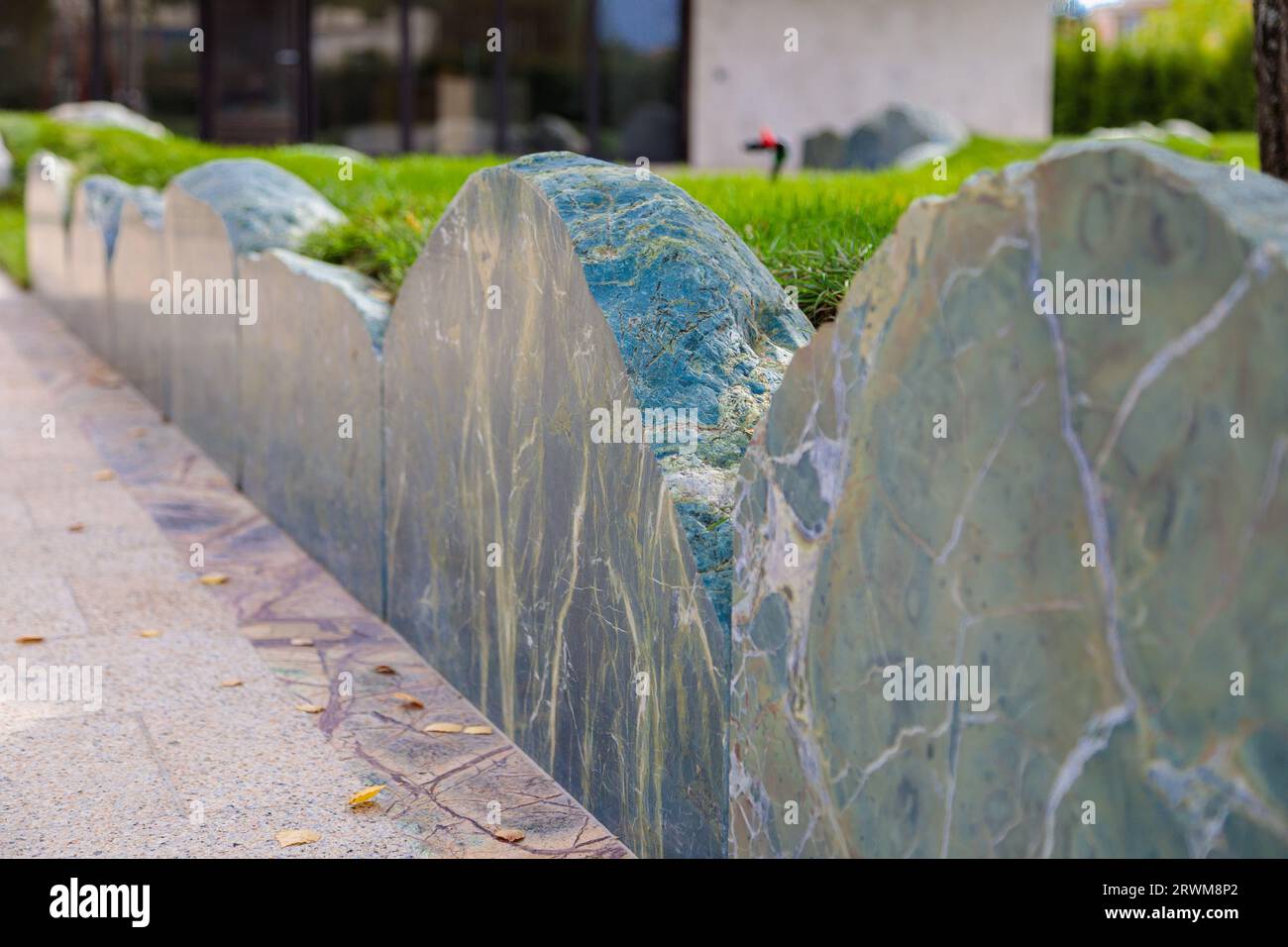 Landscaping, edging the path with boulders of diabase stone Stock Photo ...