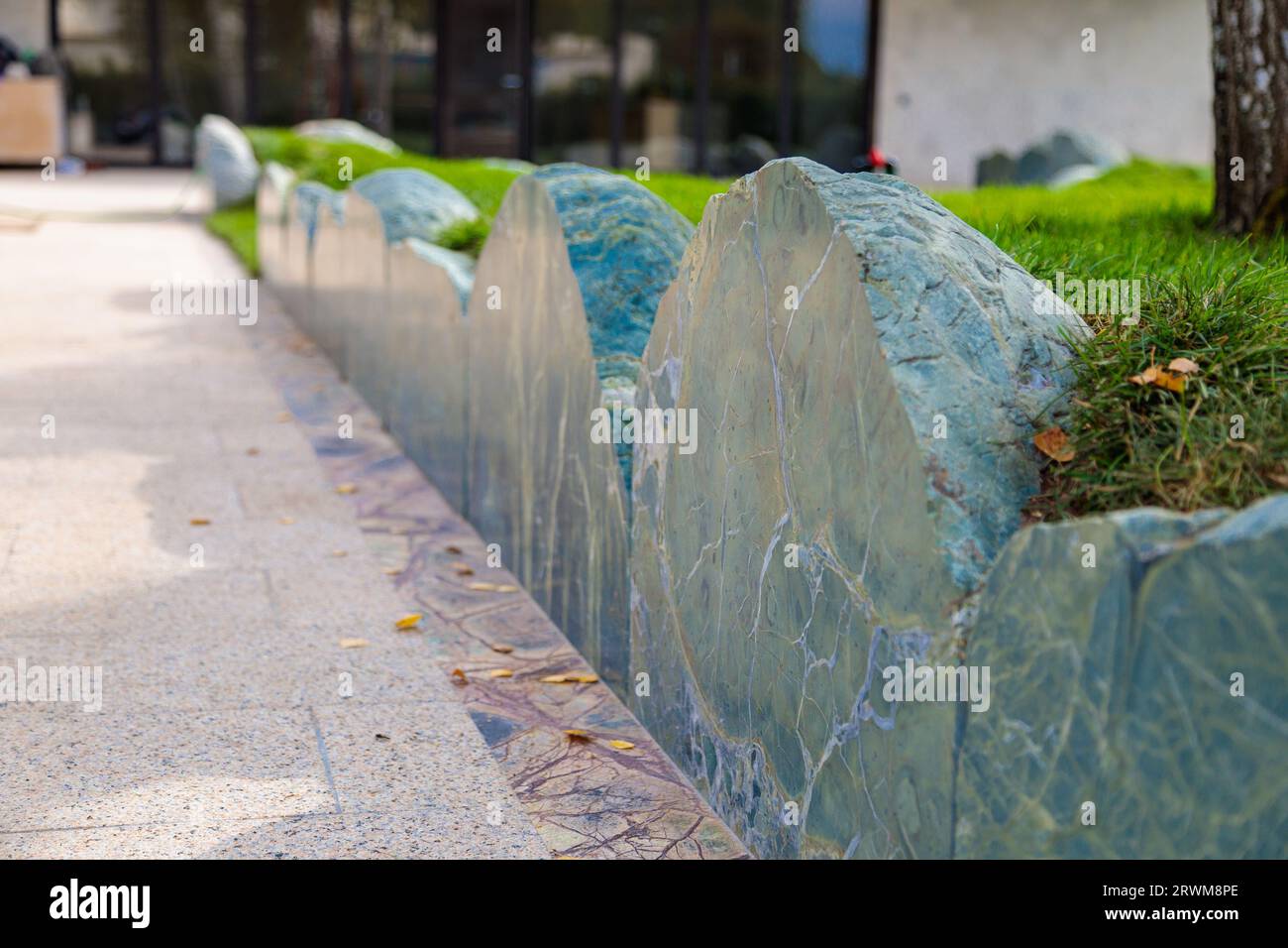 Landscaping, edging the path with boulders of diabase stone Stock Photo ...