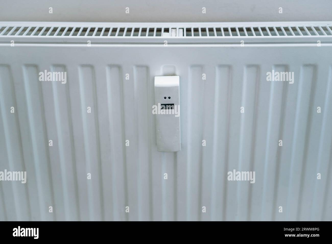 close up view of apartment radiator with smart heat meter. Energy ...
