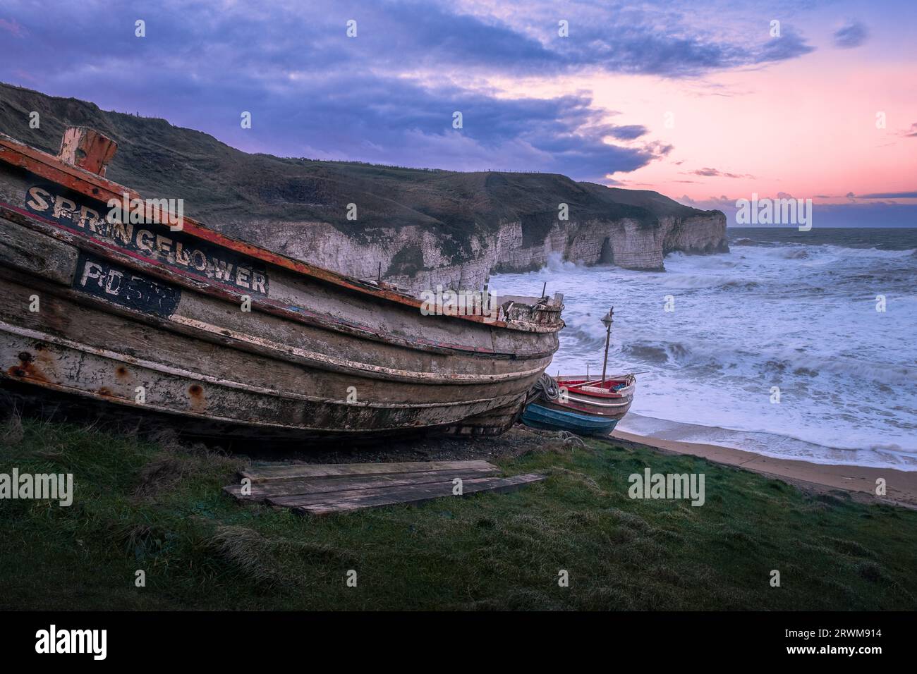 Fishing boats above a beach on the Yorkshire coast at Flamborough and ...