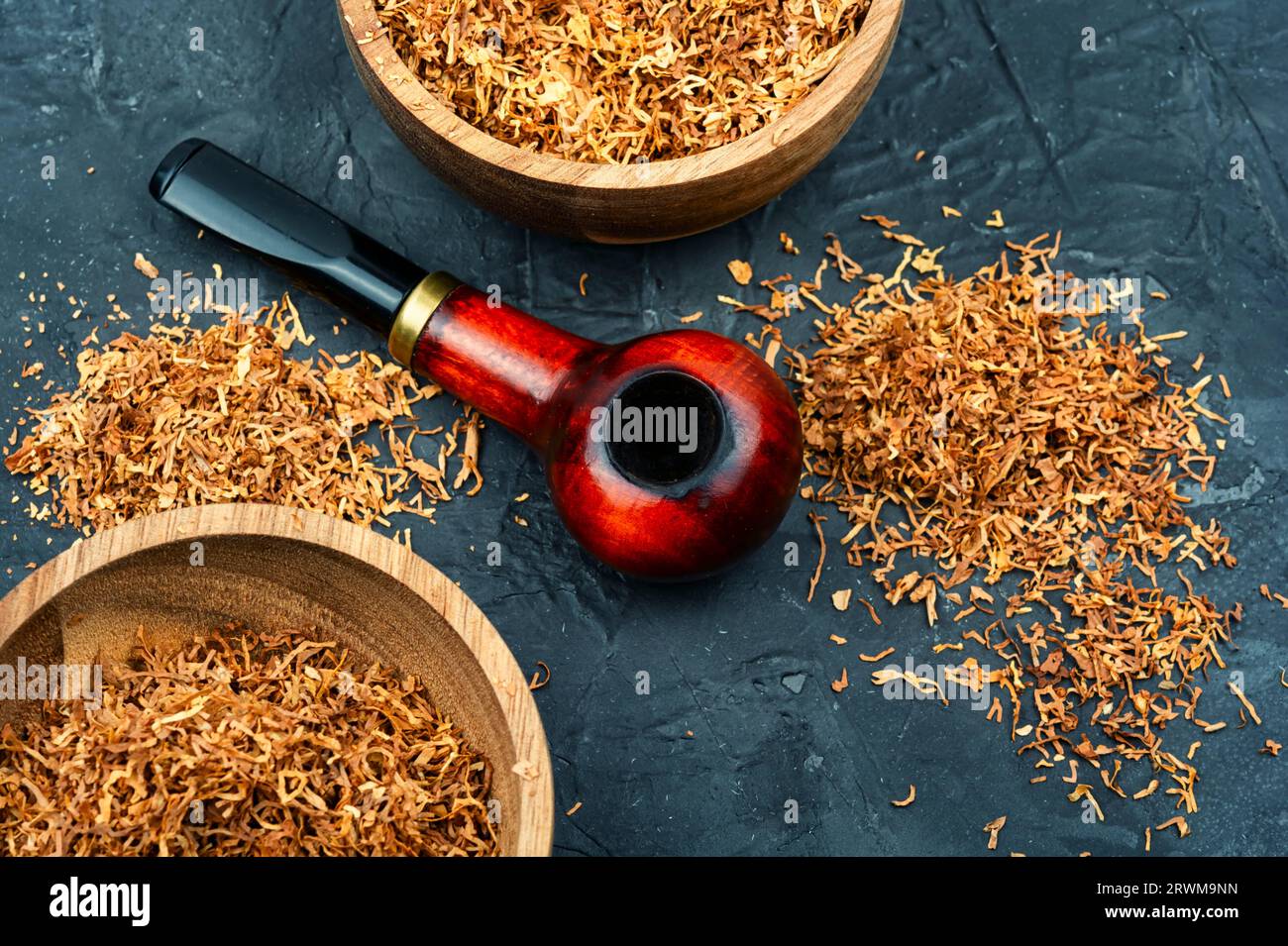 Smoking tobacco and classic wooden smoking pipe on the table for man ...