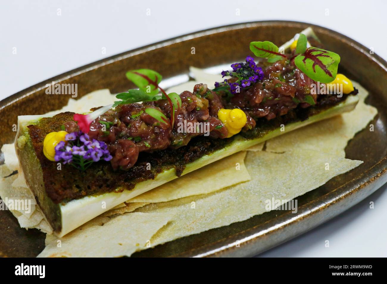 roasted split veal bone marrow with beef tartare on Stock Photo - Alamy