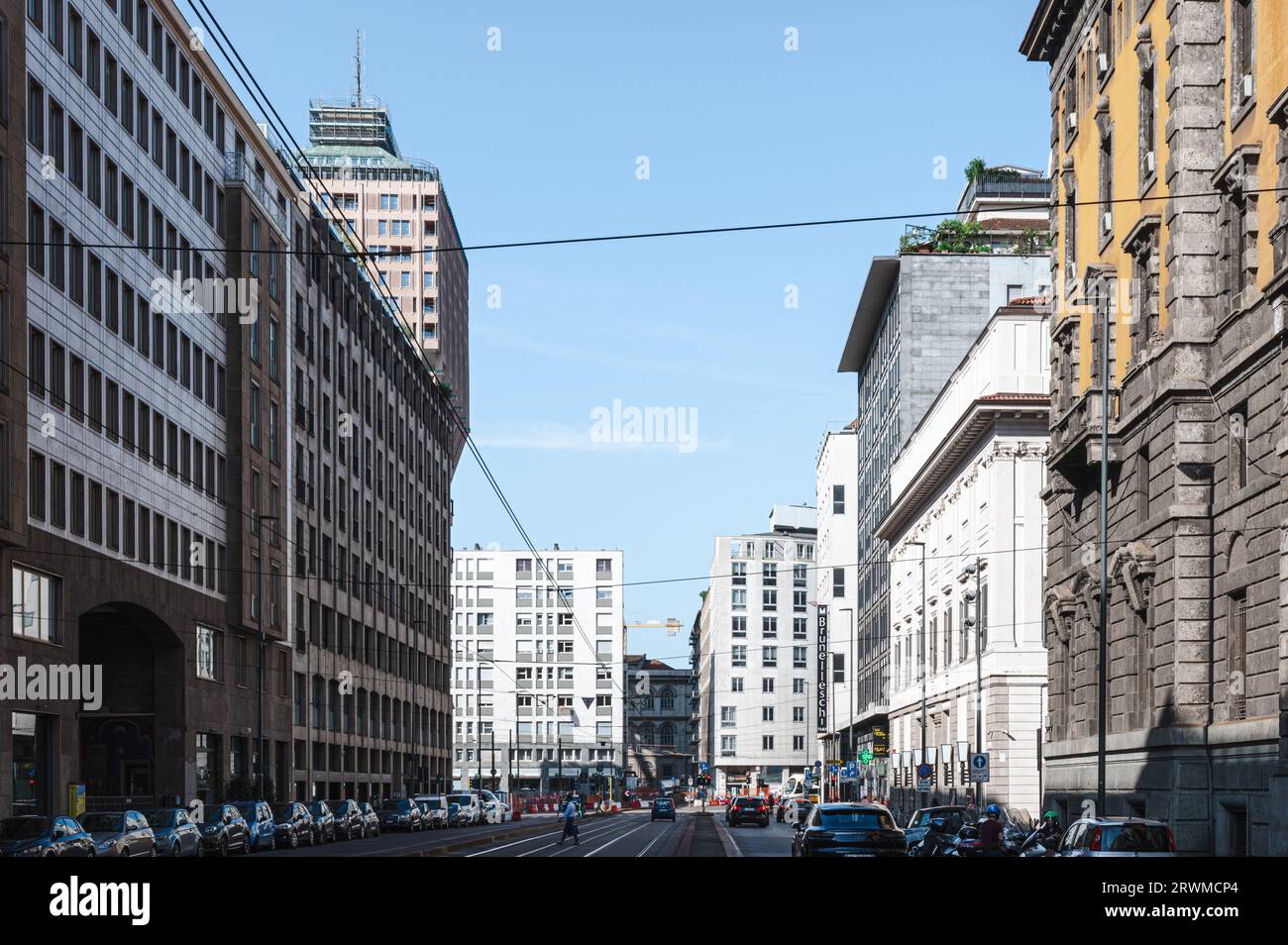 A view of a bustling city street from the sidewalk at the end of the ...