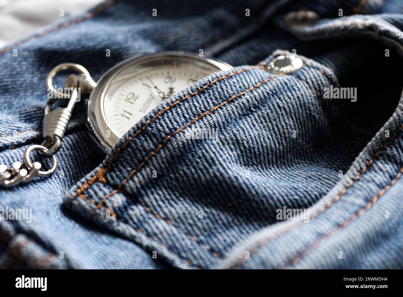 A close-up of a pocket watch inside a blue denim jean pocket Stock ...