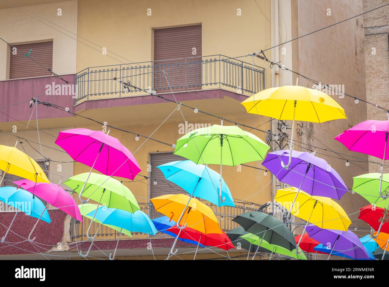 Colorful umbrellas spread out on the street. Mazara del Vallo, town in ...
