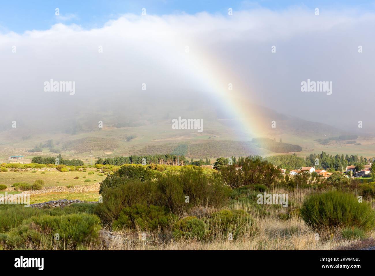 Rainbow over the cloudy rural landscape of the Central Spain, Castile ...