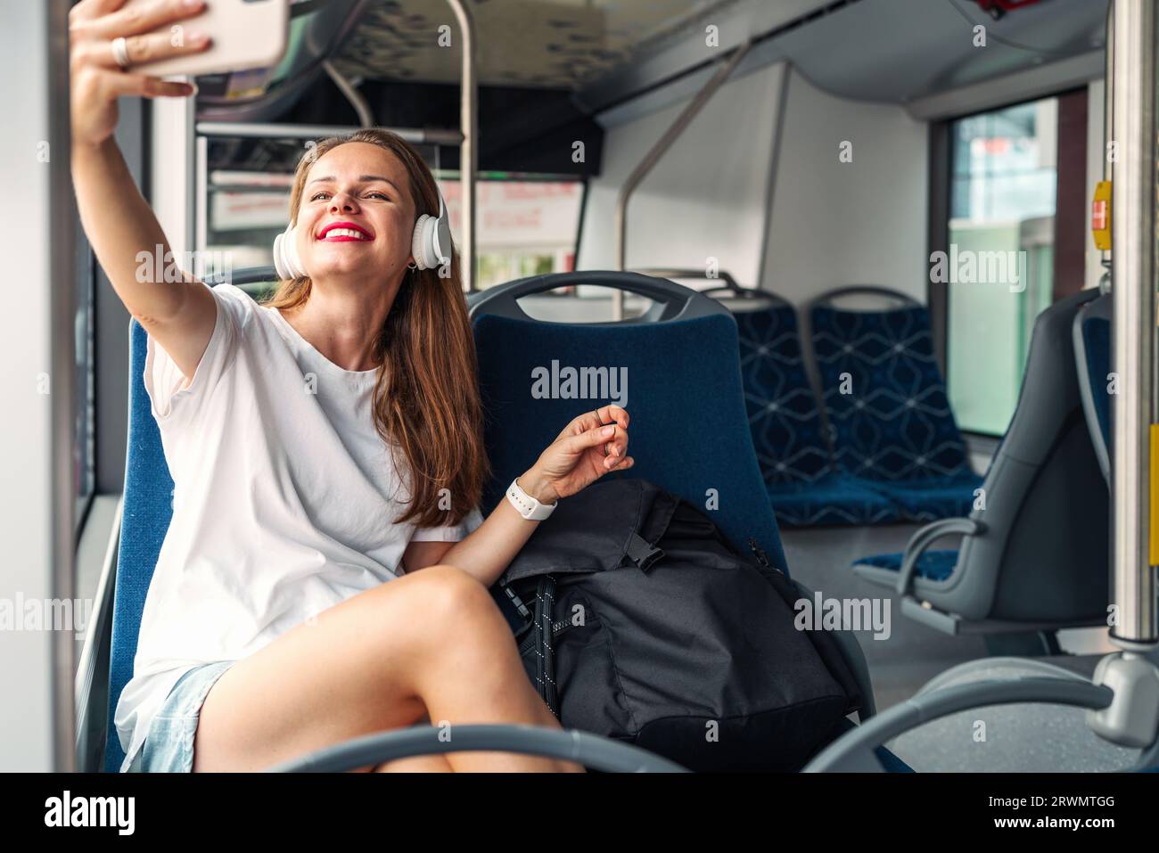 Careless young woman wearing white t-shirt, red lipstick, and ...