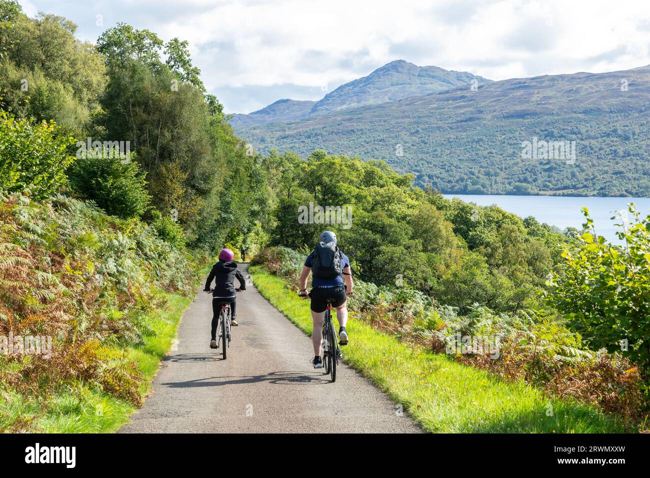 Cyclists on the road next to Loch Katrine in the Trossachs National ...
