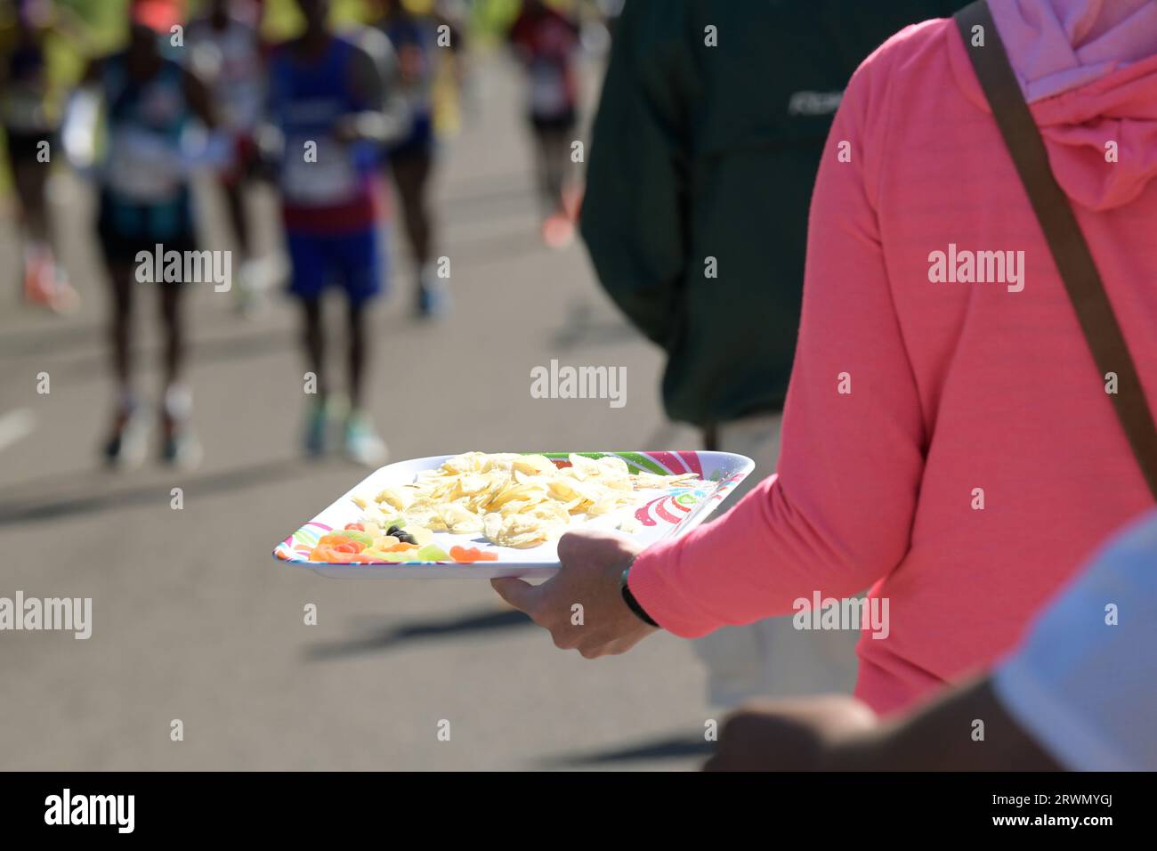 Hand of person holding food tray, snacks for athletes running 96th ...