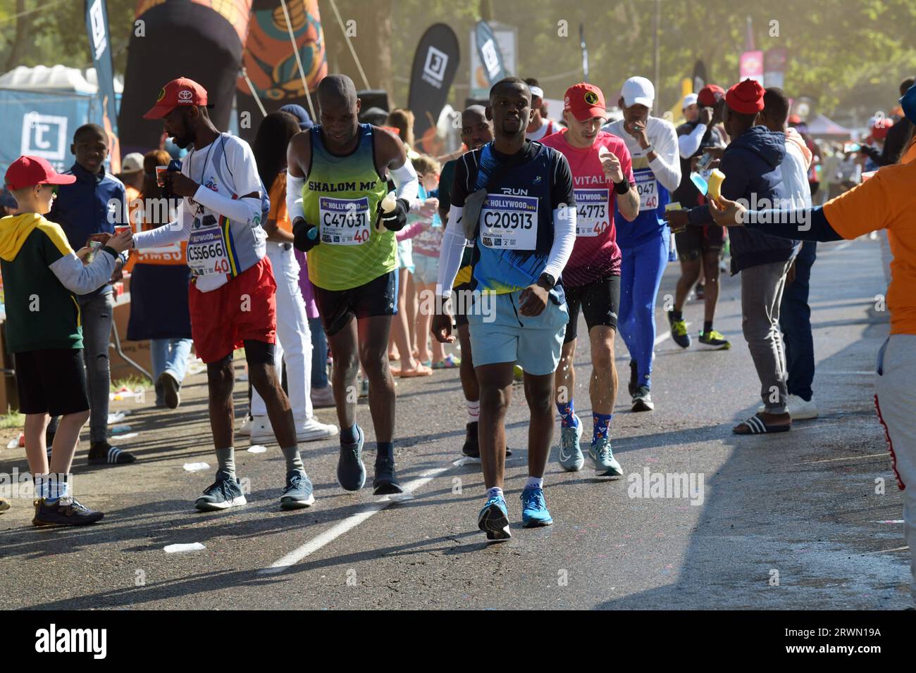 Group of competition runners at refreshment station, 96th Comrades ...
