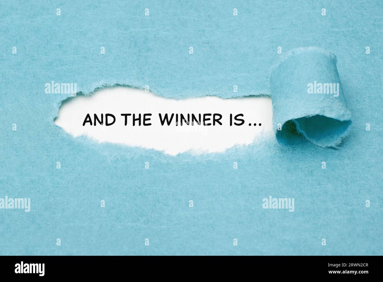 Text And the Winner is ... appearing behind torn blue paper. Winner ...