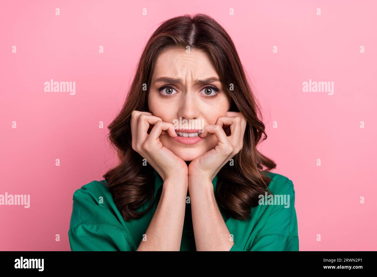 Photo of puzzled frightened girl hands cheeks biting finger nails worry ...