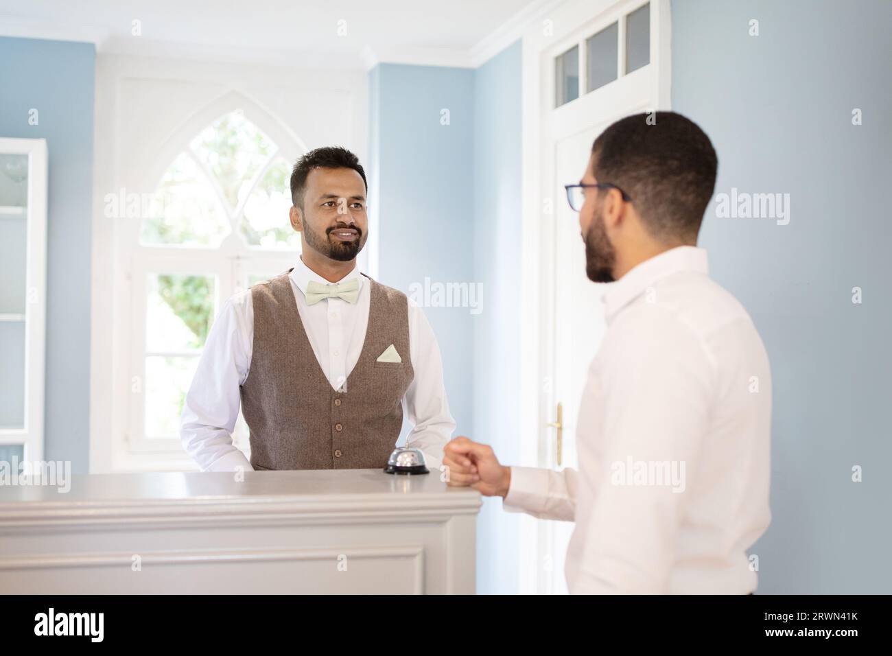 Arabic Business Man Checking At Hotel Reception Standing Near Counter ...