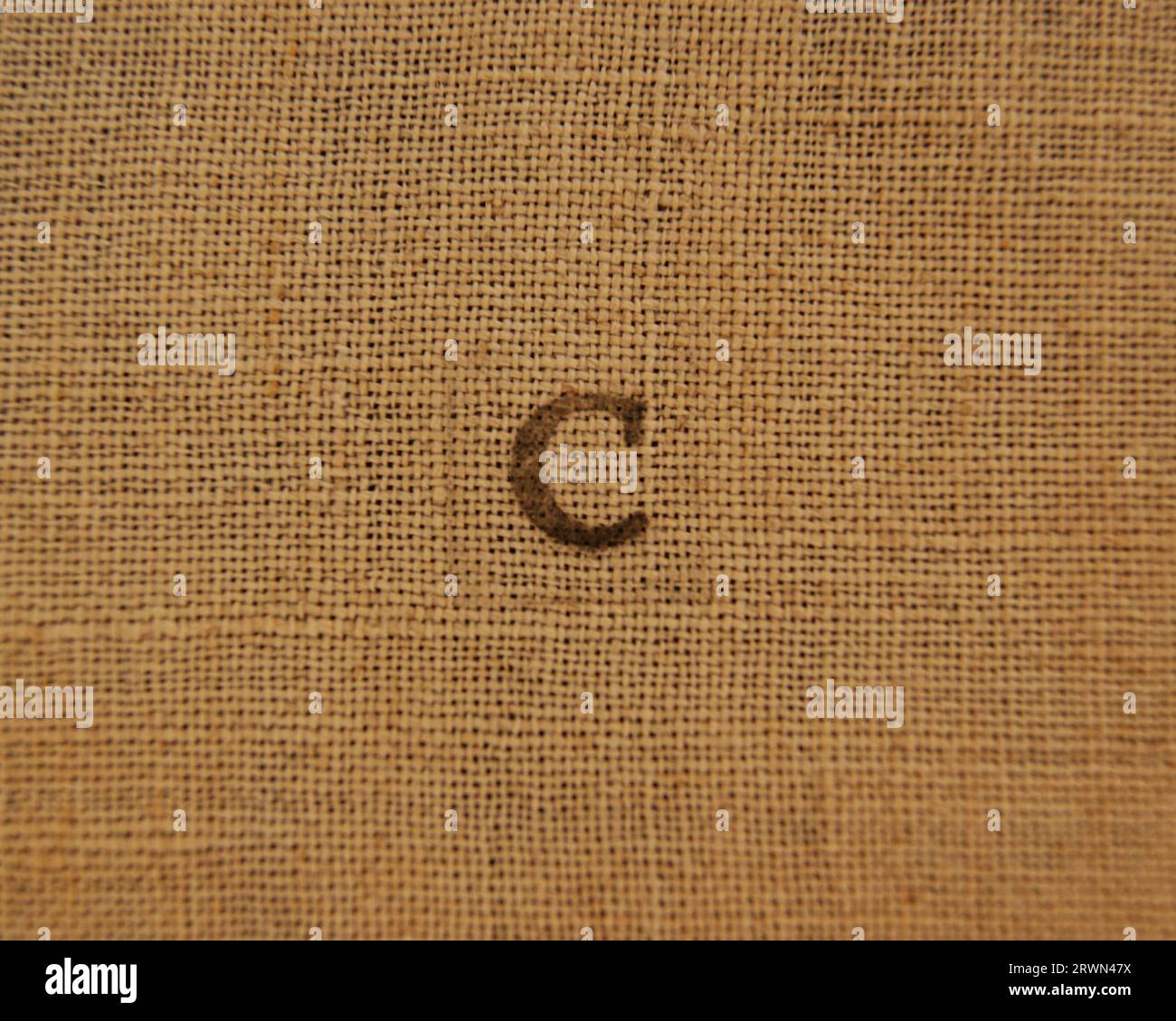 Letter C. Stamp letters on linen fabric Stock Photo - Alamy