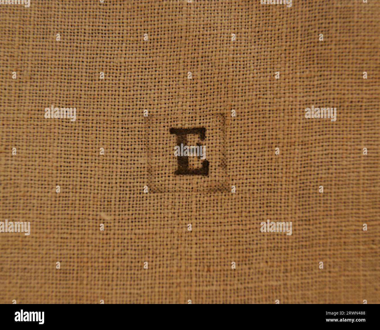 Letter E. Stamp letters on linen fabric Stock Photo - Alamy