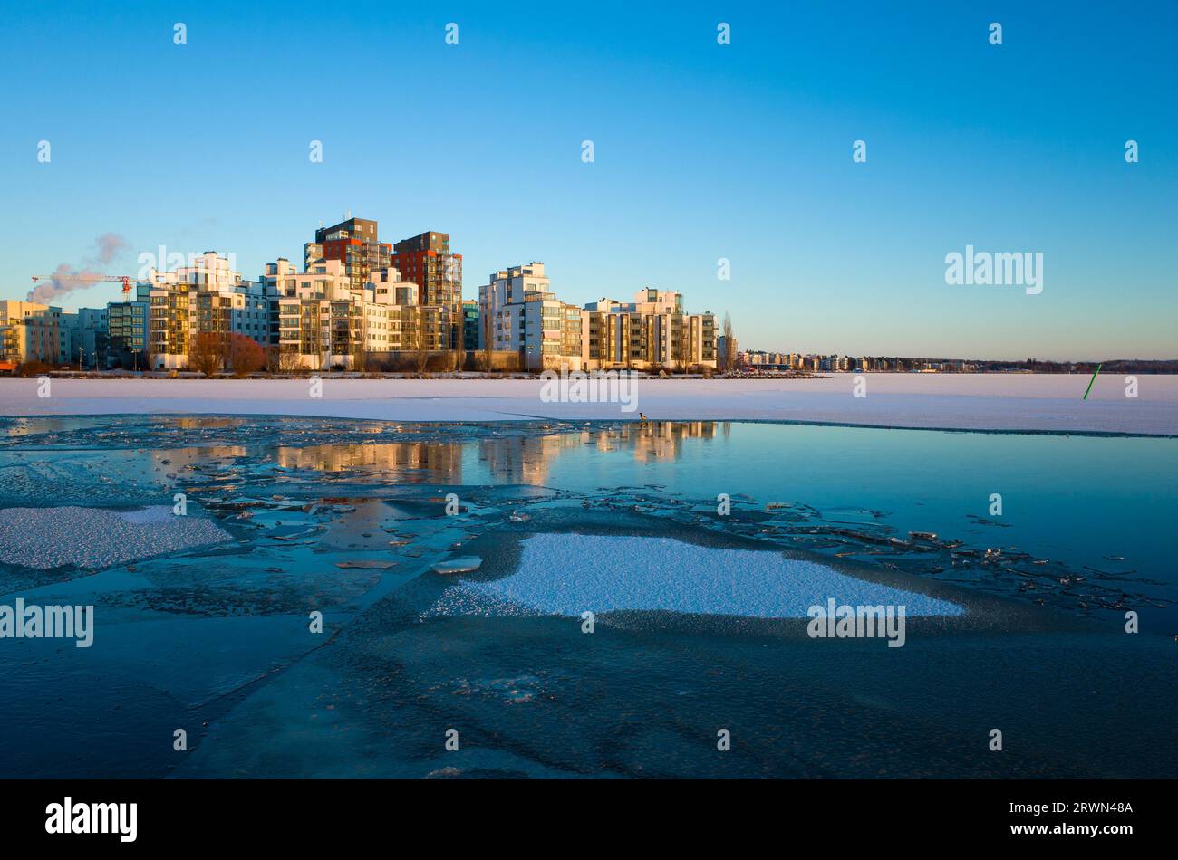 Winter day in Scandinavia, Lakeside residential complex skyline ...