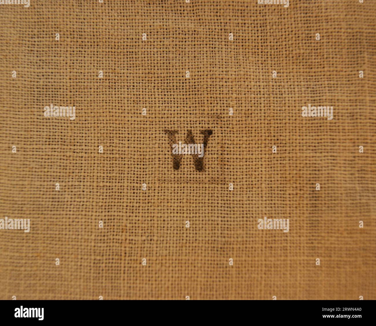 Letter W. Stamp letters on linen fabric Stock Photo - Alamy
