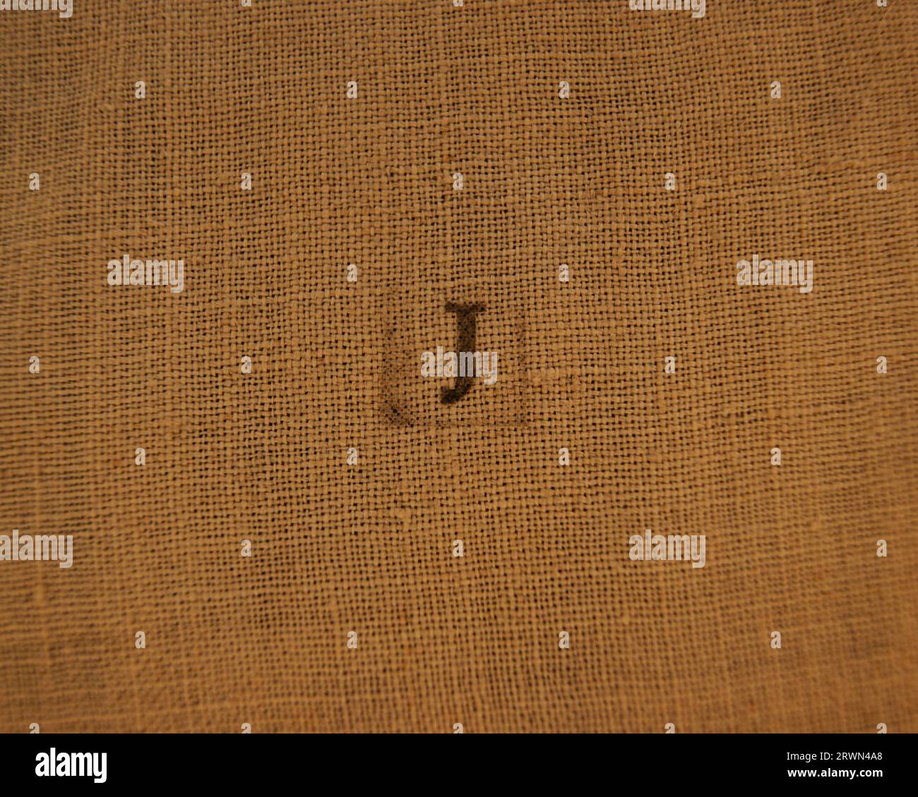 Letter J. Stamp letters on linen fabric Stock Photo - Alamy