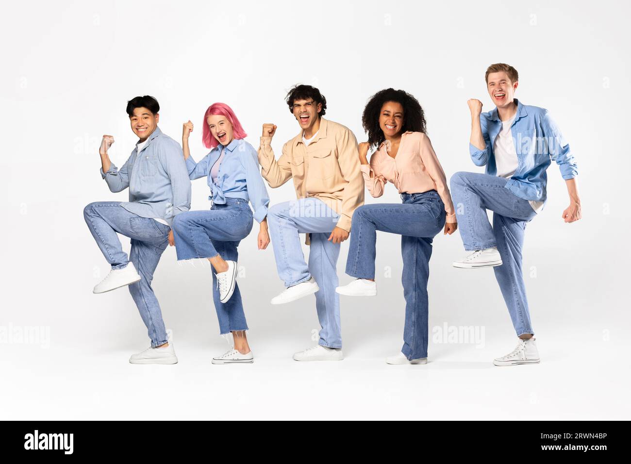 Yes. Overjoyed multiracial teen friends cheering and shaking clenched ...