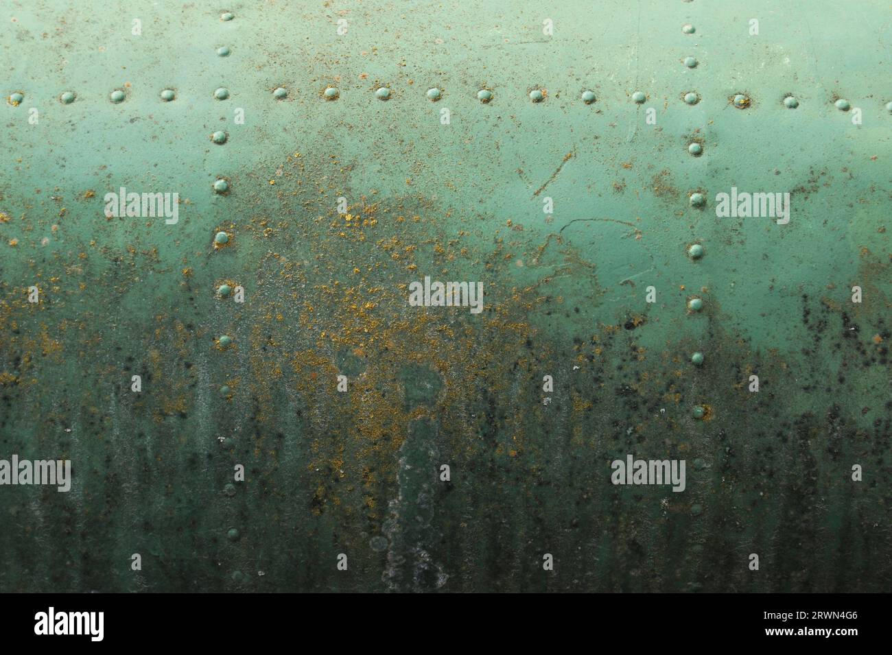 Old dirty fuselage with rivets. A fragment of the aluminum fuselage of ...