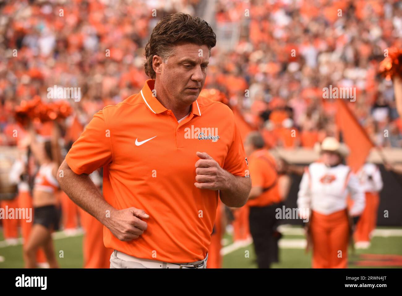 Oklahoma State head coach Mike Gundy runs on the field during an NCAA ...