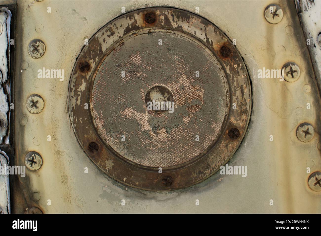 Round shaped rusted detail on the fuselage. Fragment of an old plane ...