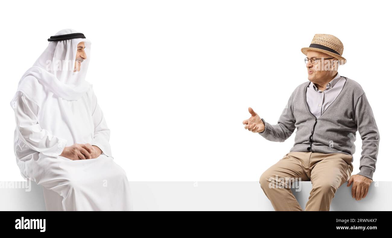 Senior gentleman sitting on a panel and talking to an arab man isolated ...