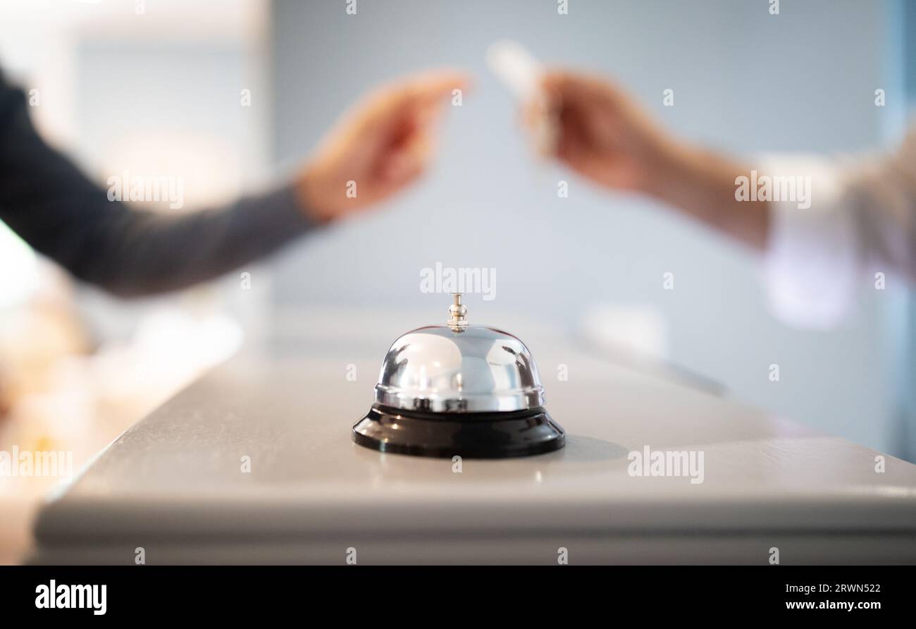Call Bell Standing On Counter At Hotel, Receptionist Giving Key Stock ...