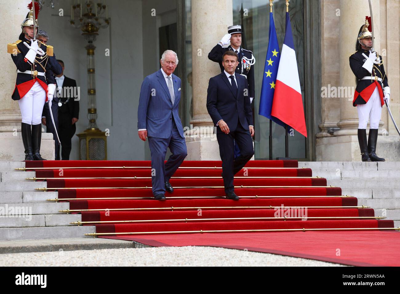King Charles III (left) walks with French President Emmanuel Macron at ...