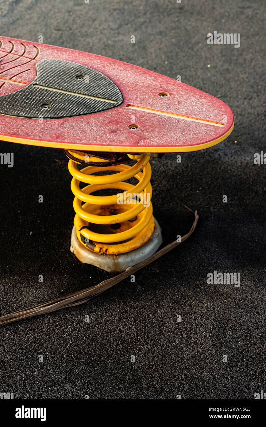 Red and yellow surfboard on springs in frozen playground Stock Photo ...