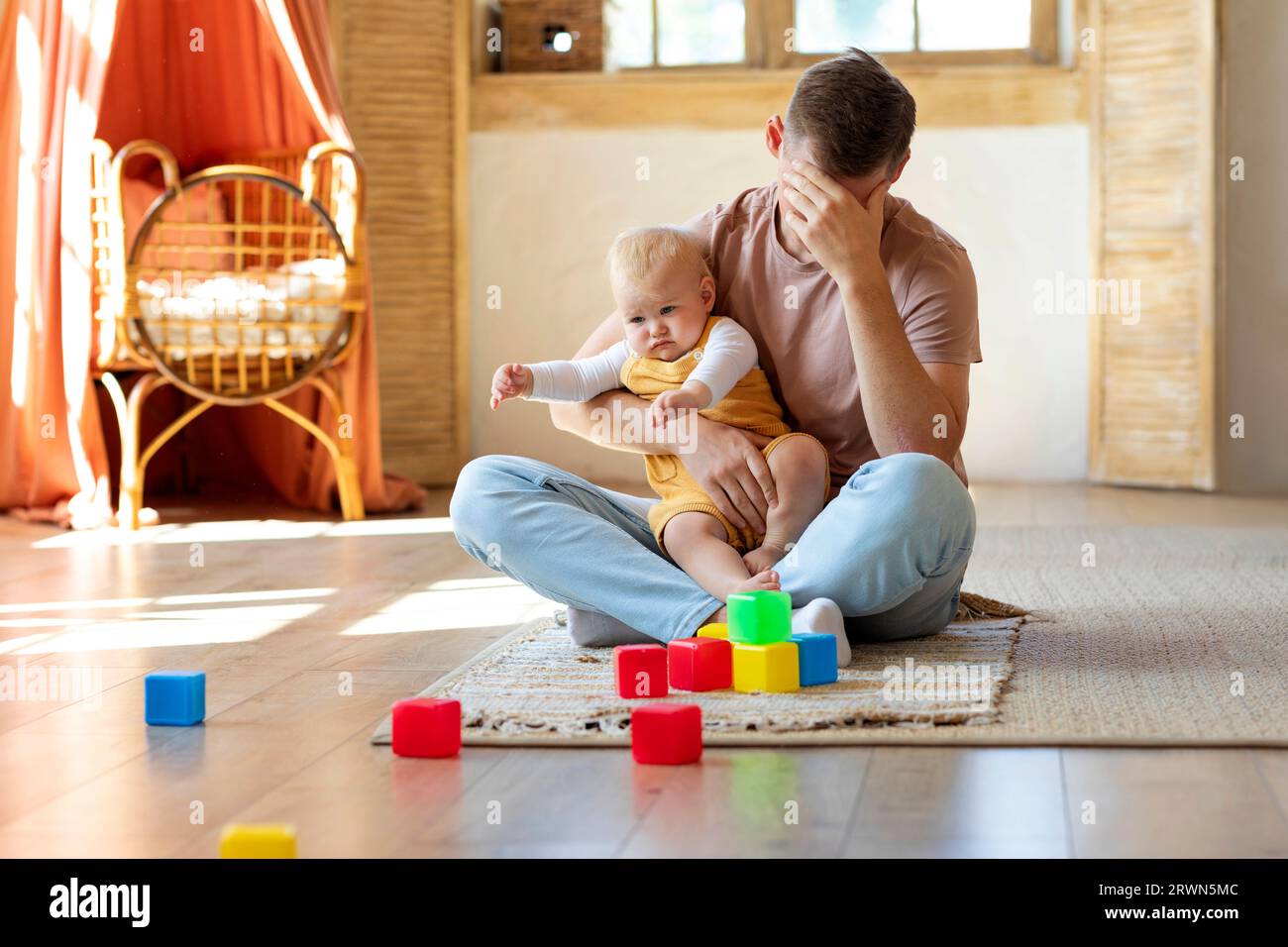 Exhausted Young Father Taking Care About Toddler Baby At Home Stock ...