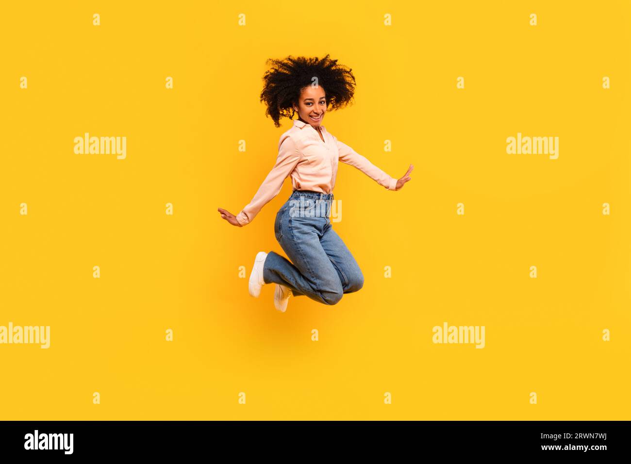 Excited black lady jumping in air and smiling at camera, female student ...