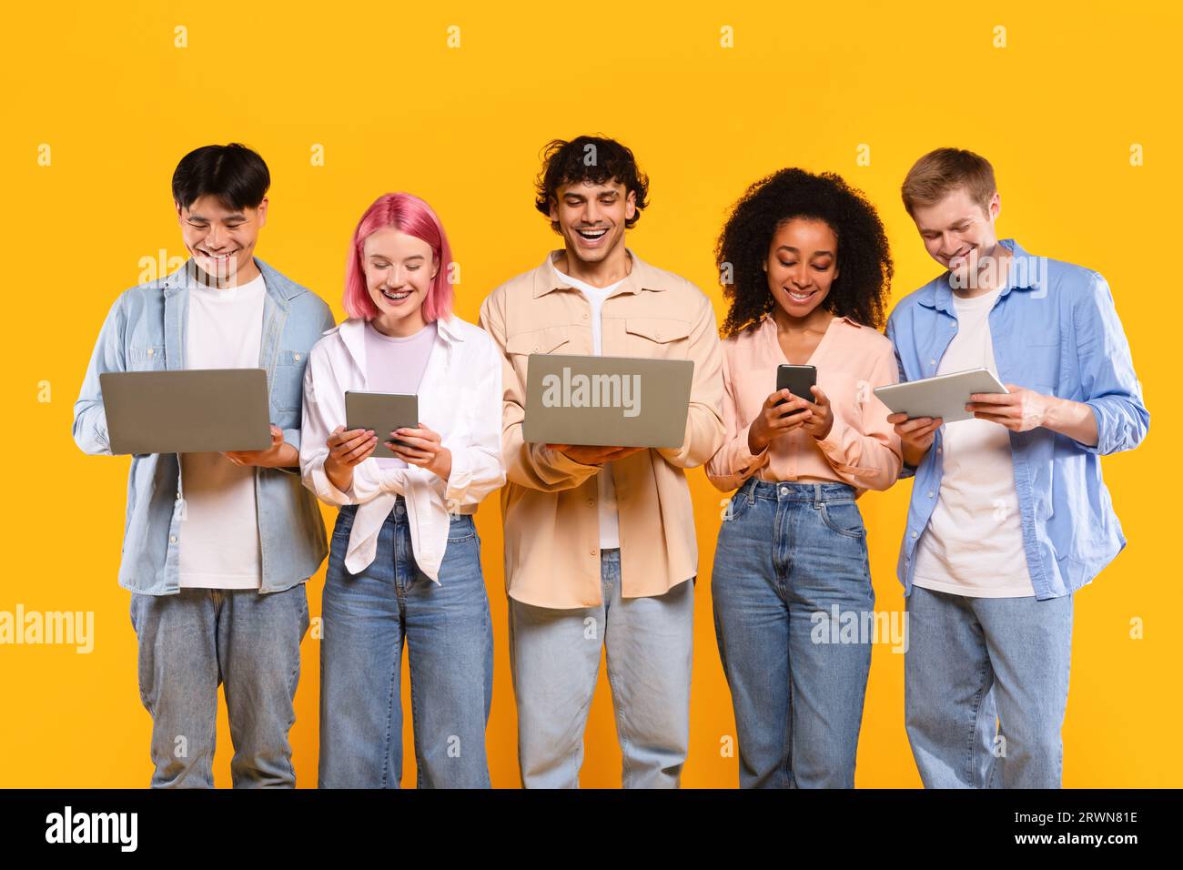 Modern gadgets for remote education. Happy diverse students friends ...