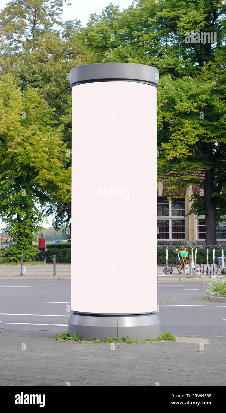 Empty advertising pillar in a city with white free copy space ...