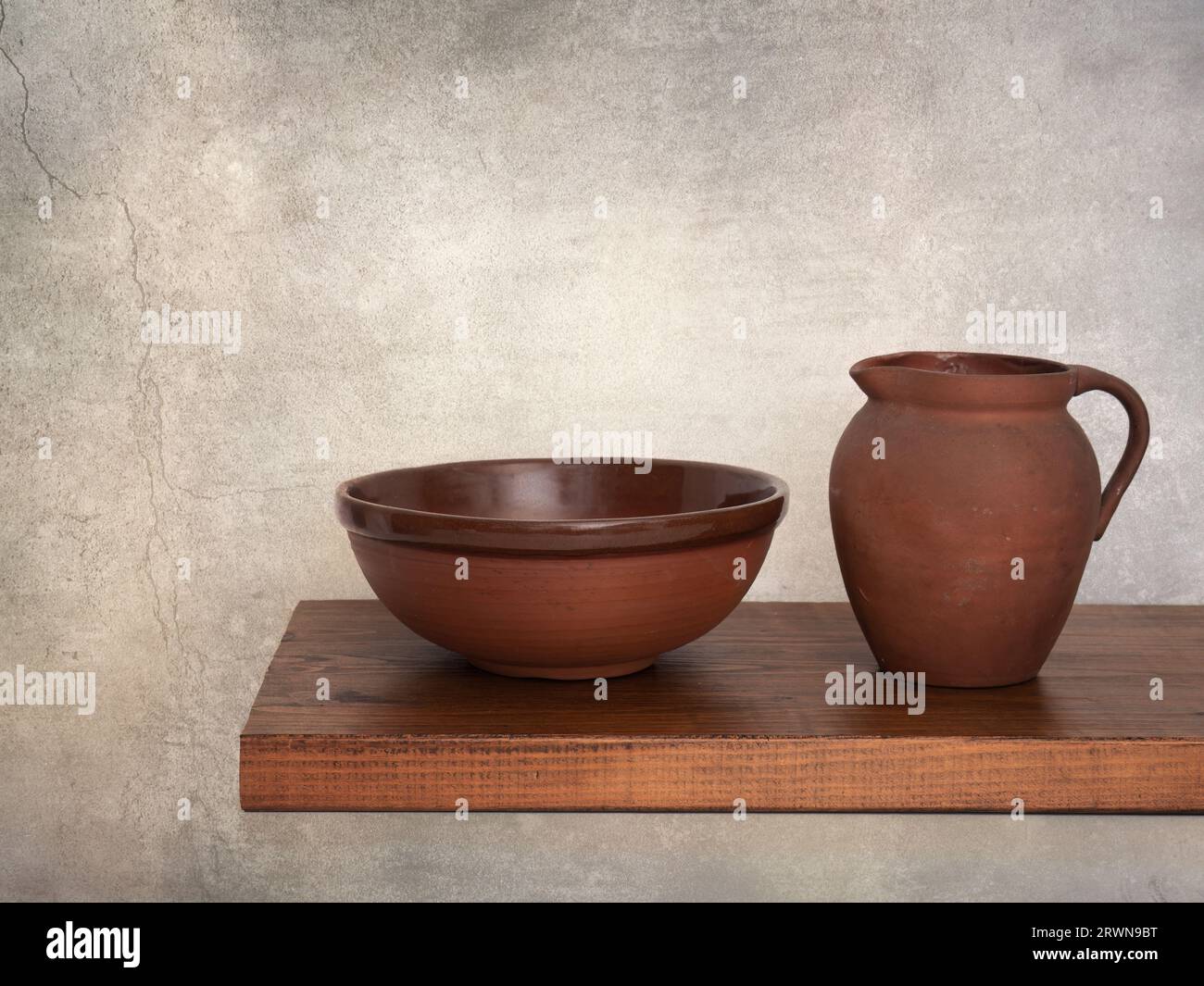 Old rustic pottery bowl and jug on shelf. Wabi sabi, simple hand made ...