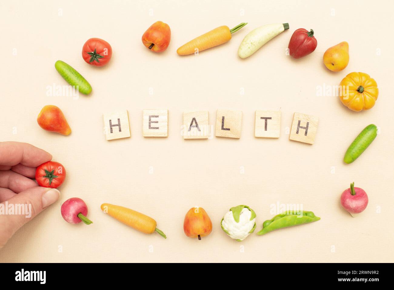 Female hand holding tomato. Different healthy food products on a beige ...