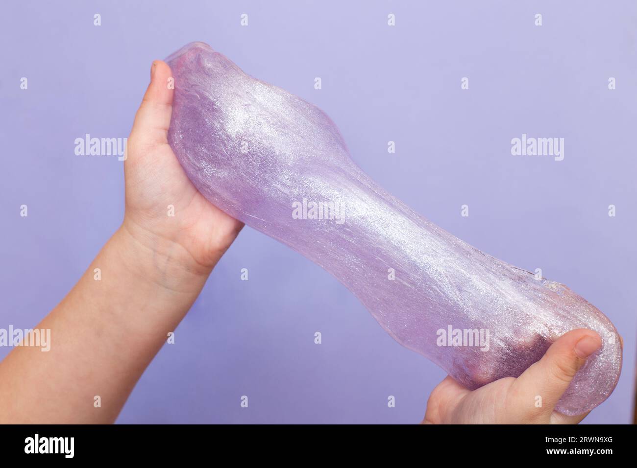 Cute kid little girl playing and making slime at home. Child hands ...