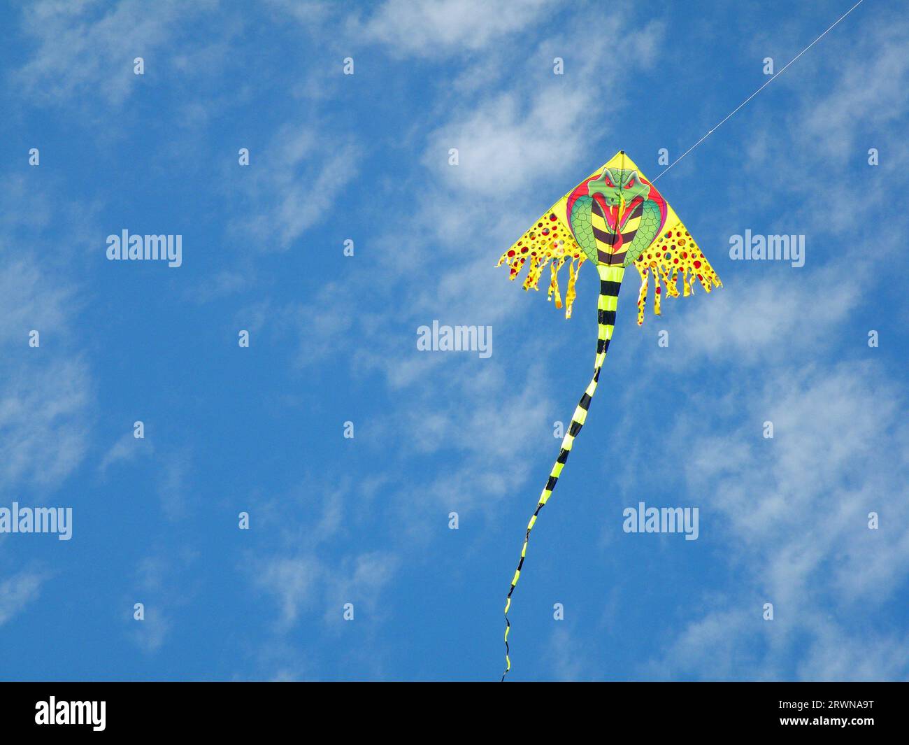Colorful kite in clear sky Stock Photo - Alamy