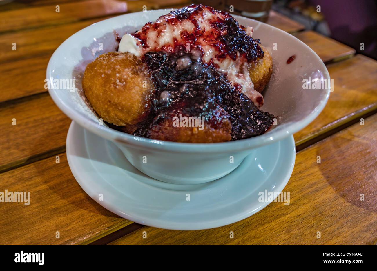 Papanasi - a traditional Romanian dessert. made from donuts covered in ...